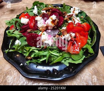 Delicious beet salad with feta cheese and walnuts in bowl isolated on ...