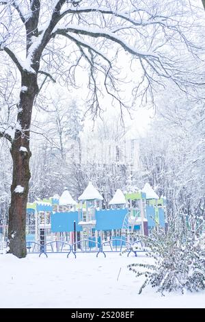 Play structures at a snow-covered playground in a residential area of ...