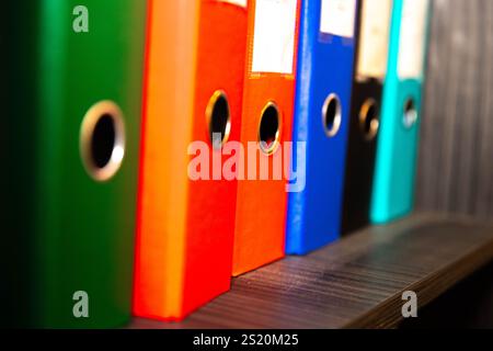 Colorful office folders on the bookshelf Stock Photo - Alamy