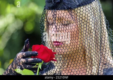 A young, grieving widow with a veil and rose. Death and inheritance ...