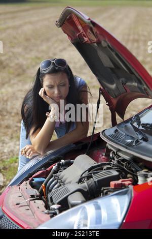 Young woman's car breaks down. Engine failure Stock Photo - Alamy