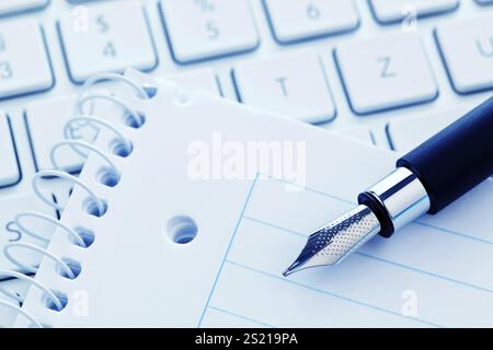A notepad and the keyboard of a computer. Take notes and save them ...