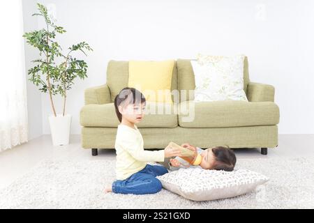 Child taking care of younger sister Stock Photo - Alamy