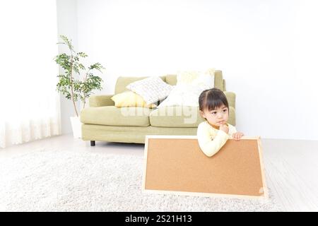 Crying child holding board Stock Photo - Alamy