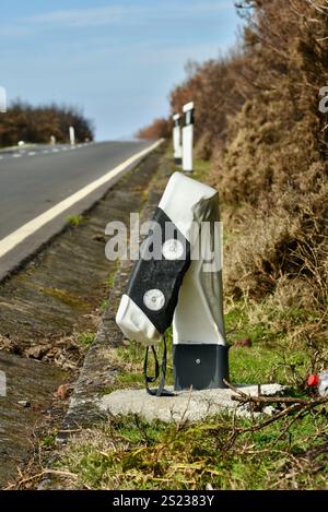 Melted and deformed plastic roadside marker posts with burnt trees and ...