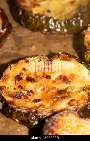 Closeup of grilled eggplant slices seasoned with spices on brown plate ...