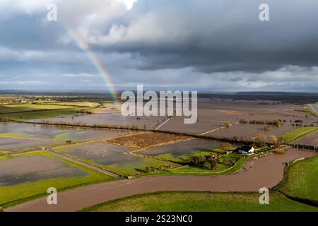 A rainbow is seen over flooded fields near the River Tone in Somerset ...