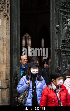 Visitors wearing face masks exiting the Normandy American Cemetery in ...