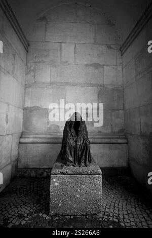 Black and white photo of monument of scary ghost sitting on stone Stock ...