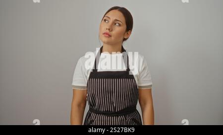 Beautiful hispanic woman cleaning cooking pan with scourer clueless and ...
