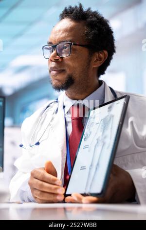 African american medic presenting the diagnostic reports to a female ...