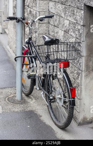 A bicycle was secured to a pole to protect it against theft. Bicycle ...