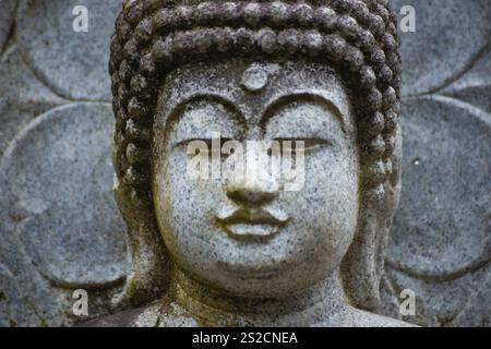 A religious stone statue of Akshobhya at Japanese buddhism temple Stock ...