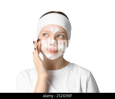 Teenage girl washing her face with cleanser on white background ...