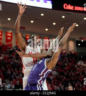 Houston forward Joseph Tugler (11) goes up for a shot against Central ...