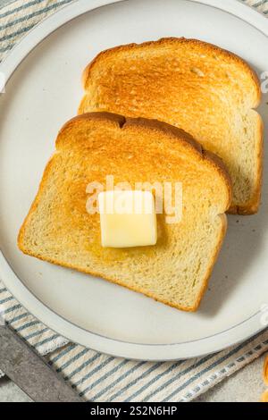 Homemade Buttered Toast on a white plate, top view. Flat lay, overhead ...