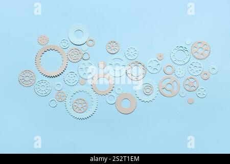 Different paper gears on blue background Stock Photo - Alamy