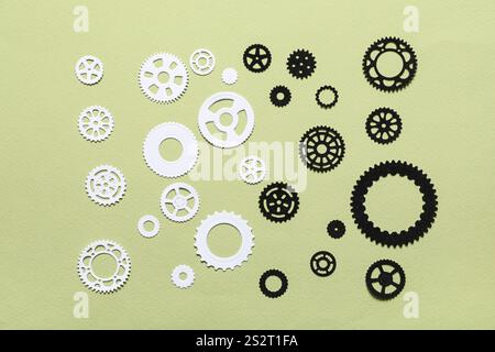 Different paper gears on green background Stock Photo - Alamy