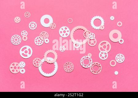 Different paper gears on pink background Stock Photo - Alamy