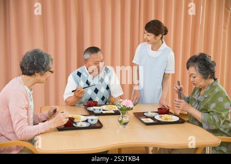 Senior and care worker eating in nursing home Stock Photo - Alamy