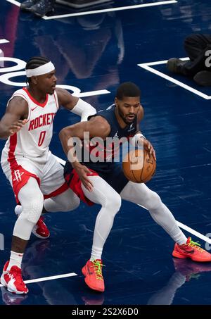 Houston Rockets guard Aaron Holiday controls the ball during an NBA ...