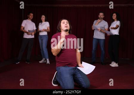 Professional actors with their scripts rehearsing in theatre Stock ...