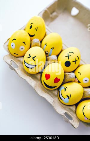 Funny smiley painted egg face in bird feather. Easter decorations. Copy ...