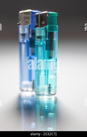 Two lighters in vibrant dark and light blue shades stand side by side ...