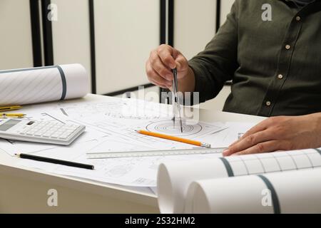 Engineer working with project, closeup. Different technical drawings on ...