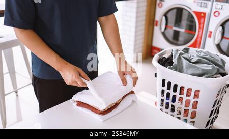 Man doing launder holding basket with dirty laundry of the washing ...