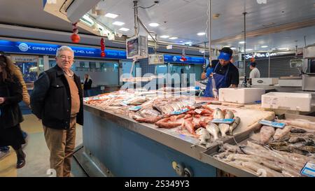 Local residents browse fresh produce inside the Faro Municipal Market ...