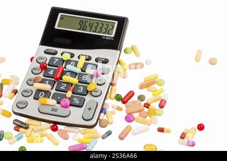 Tablets lying on a calculator. Symbol photo for costs in the medical ...