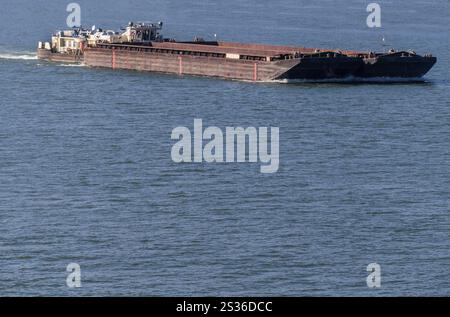 Freighter with bulk goods underway, symbol for shipping, freight ...