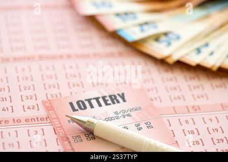 Lottery ticket and gambling receipt on table with pen and European ...