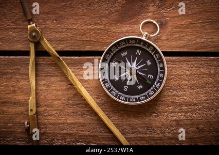 Vintage drawing and navigational Compass on a rustic wooden board Stock ...
