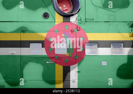 Dominica flag depicted on side part of military armored tank close up ...