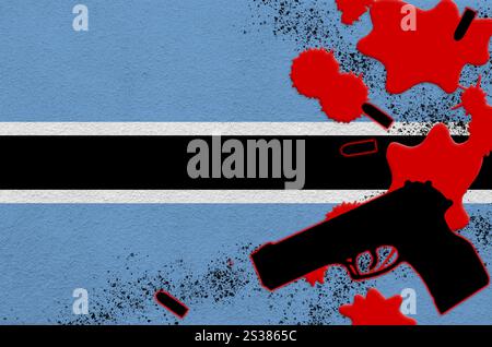 Botswana flag and black firearm in red blood. Concept for terror attack ...