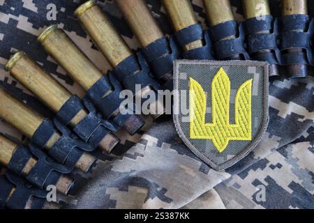 Ukrainian army symbol on machine gun belt lies on ukrainian pixeled ...