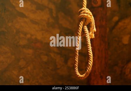 Noose in prison of old castle cellar and grunge stone wall close up ...