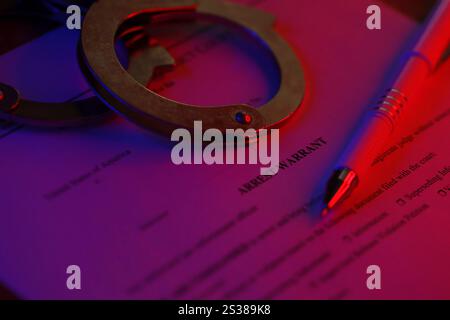 District Court Arrest Warrant court papers with handcuffs and blue pen ...