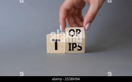 Top Tips symbol. Businessman hand Turnes cubes with words Top Tips ...