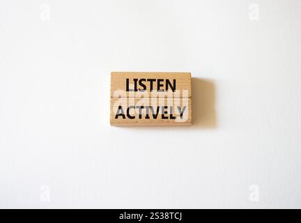 Listen actively symbol. Wooden blocks with words Listen actively ...