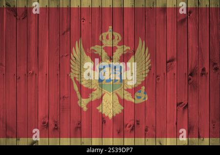 Montenegro flag depicted in bright paint colors on old wooden wall ...