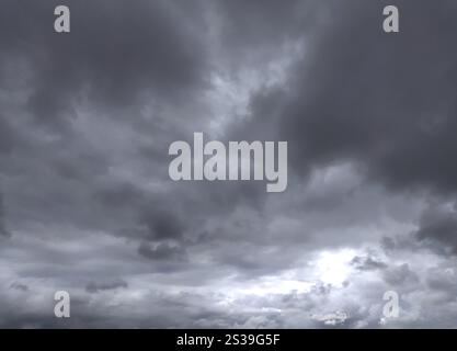 Twilight landscape with dark ominous storm clouds and fading orange ...