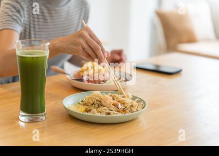 Non binary man business worker talking on smartphone writing on ...
