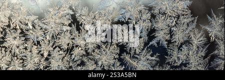 Snowflakes frost rime macro on window glass pane. Colorful ice on the ...