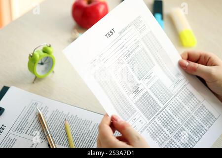 Female student hands testing in exercise and taking fill in exam paper ...