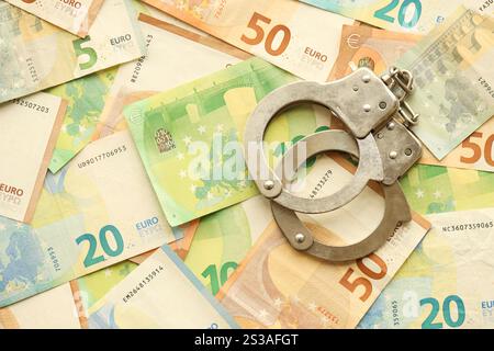 Handcuffs and euro money. Euro banknotes Stock Photo - Alamy
