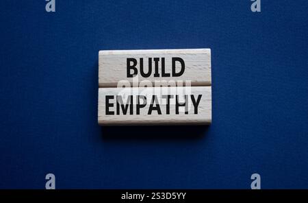 Build empathy symbol. Wooden blocks with words Build empathy. Beautiful ...