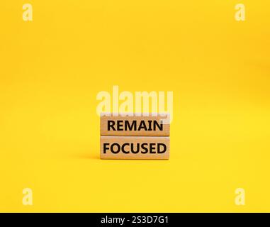 Remain focused symbol. Concept words Remain focused on wooden blocks ...